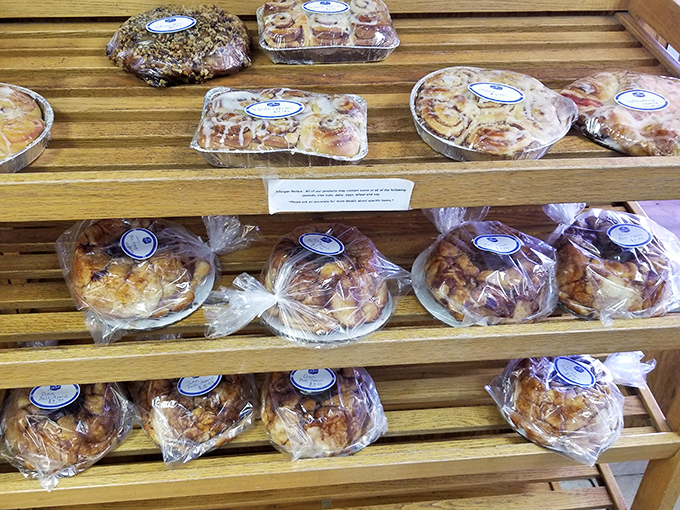 Packaged pastries lined up on wooden shelves &ndash; because sometimes you need to bring home reinforcements for later sugar emergencies.