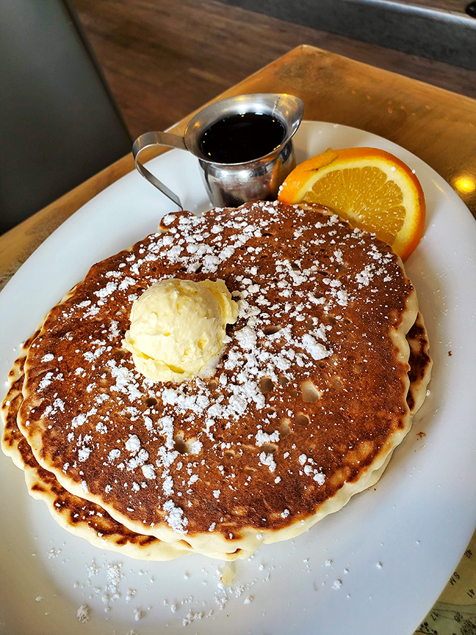 Fluffy pancakes dusted with powdered sugar like fresh snow on a perfectly golden California morning.