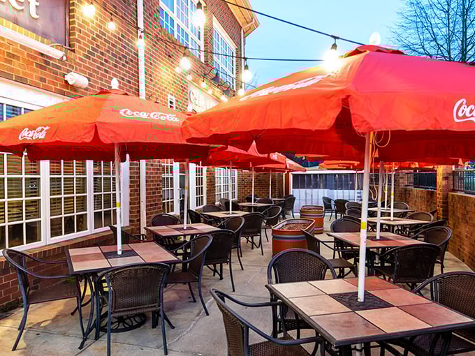 The patio where summer evenings stretch into memory. Those red umbrellas aren't just shade&mdash;they're mood enhancers.