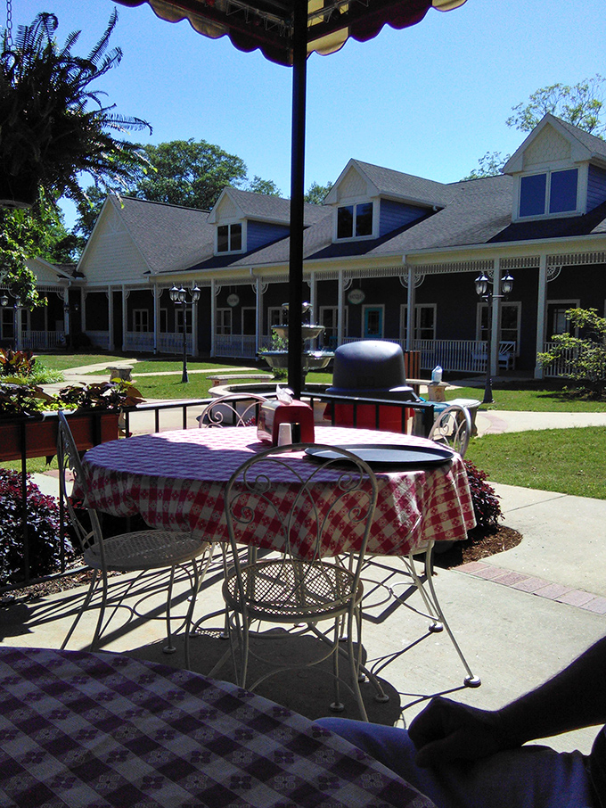 The outdoor patio offers a peaceful retreat with checkered tablecloths that whisper, "Stay awhile, the real world can wait."