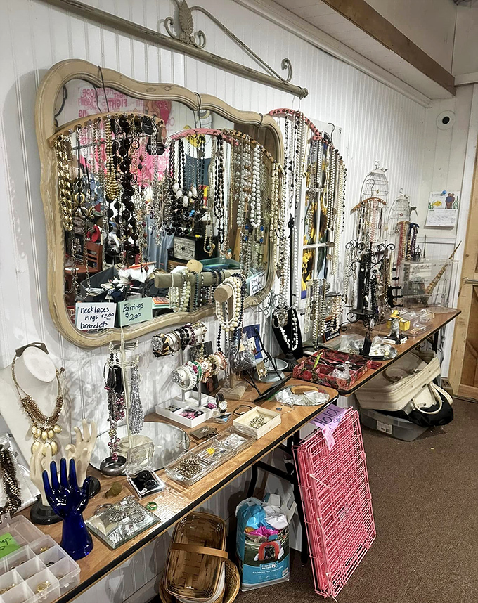 Jewelry displayed on a vintage vanity mirror creates a glamorous vignette. Someone's going to score grandmother-approved accessories at granddaughter prices.