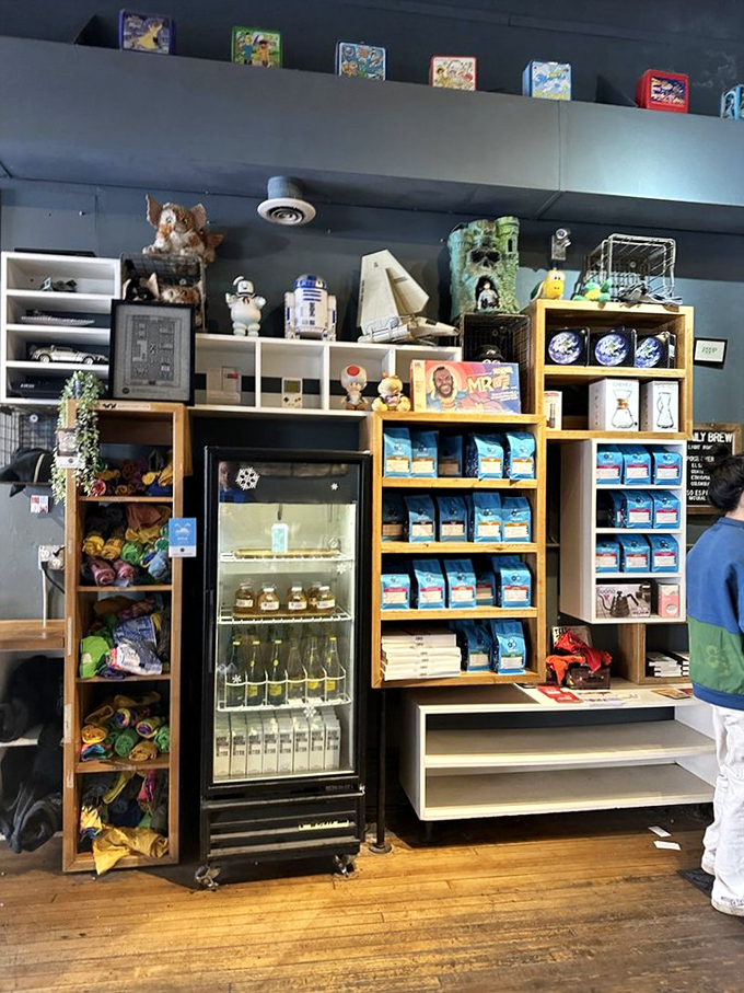 The retail wall is a treasure trove of coffee beans, vintage toys, and '80s memorabilia. R2-D2 stands guard over the refrigerated beverages.