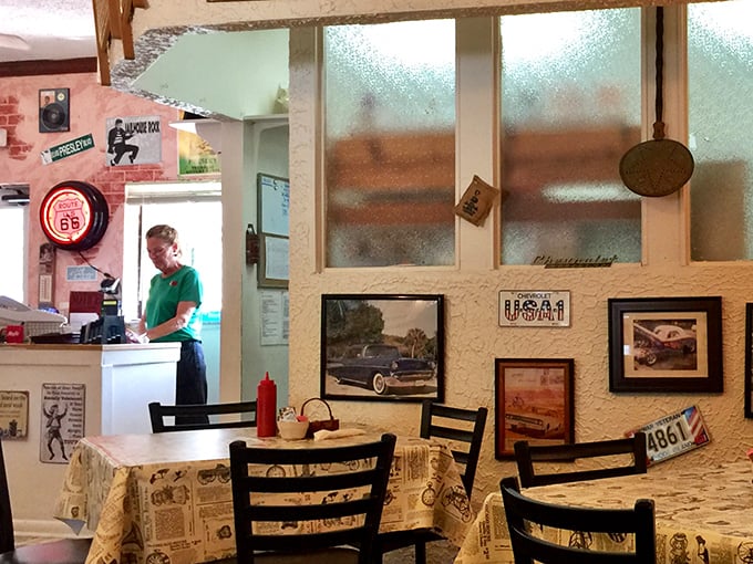 Where vintage meets function. Old license plates and car photos share space with everyday restaurant operations, creating a museum-meets-diner atmosphere.
