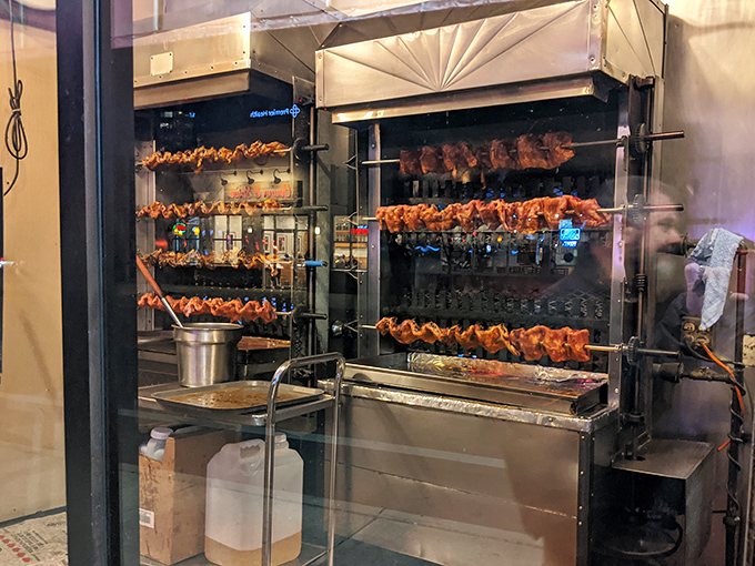 Rotisserie chickens spinning like a delicious carousel of smoky possibilities.