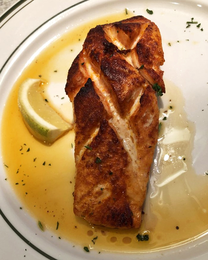 Salmon that wears its perfect sear like a badge of honor, swimming in a buttery sauce that begs to be sopped up with anything within reach.