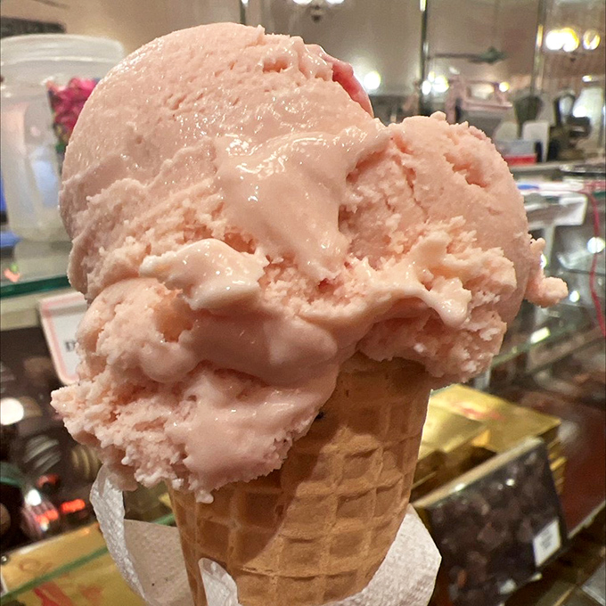 A scoop of strawberry ice cream that makes you wonder if they've somehow improved upon the concept of strawberries themselves.