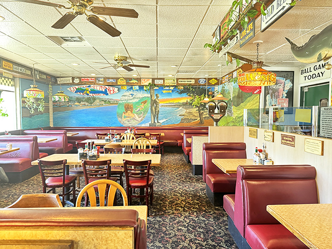 The dining room where beach murals and red vinyl create the perfect backdrop for family celebrations and recovery breakfasts after boardwalk adventures.