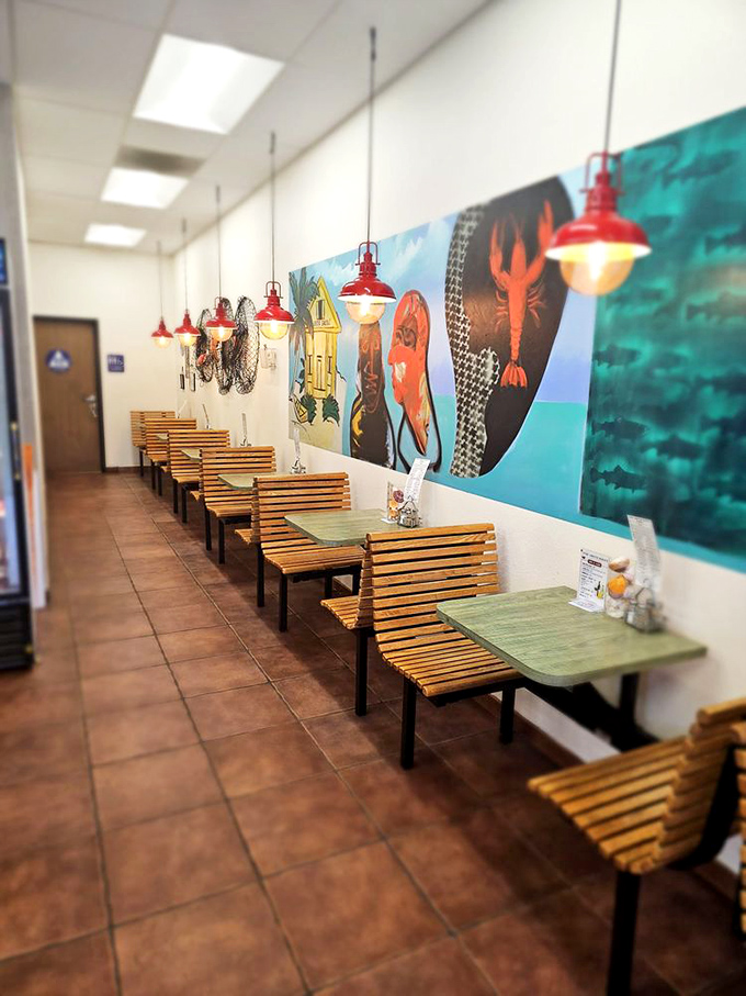 Red pendant lights hang like buoys above wooden tables, while maritime murals transport diners from strip mall to seaside without the parking hassle.