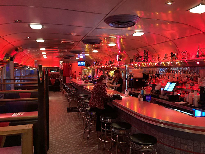 The diner transforms after dark, bathed in red light that makes everyone look like they're starring in their own late-night movie.