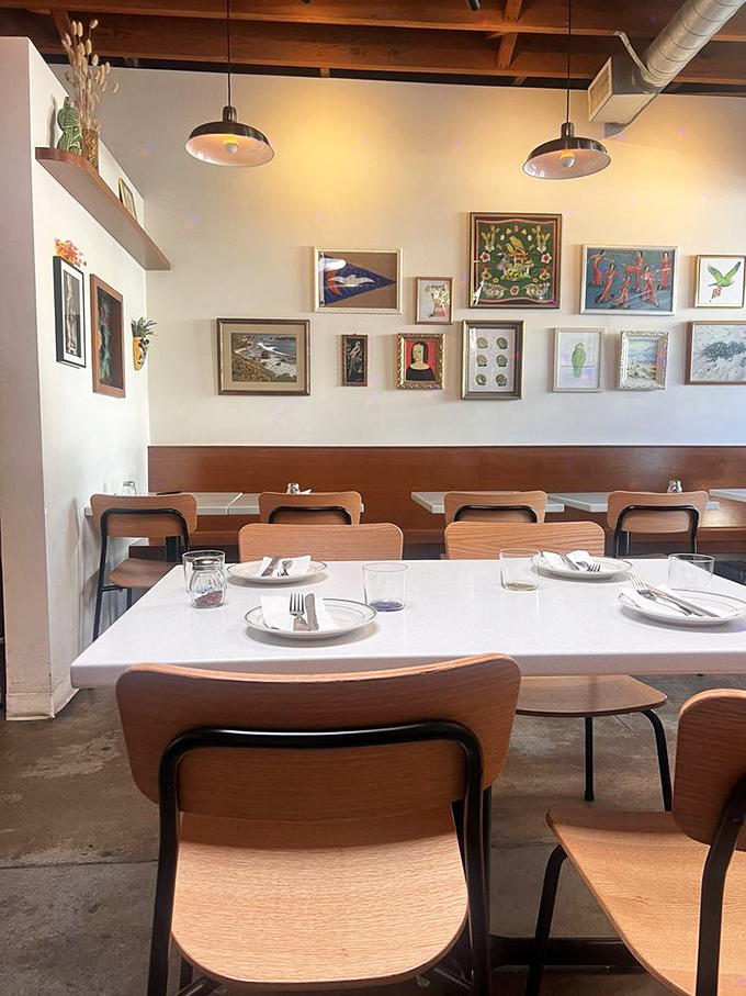 Gallery wall meets dining room in a space that feels like eating in an art collector's kitchen&mdash;if that collector really understood comfort.