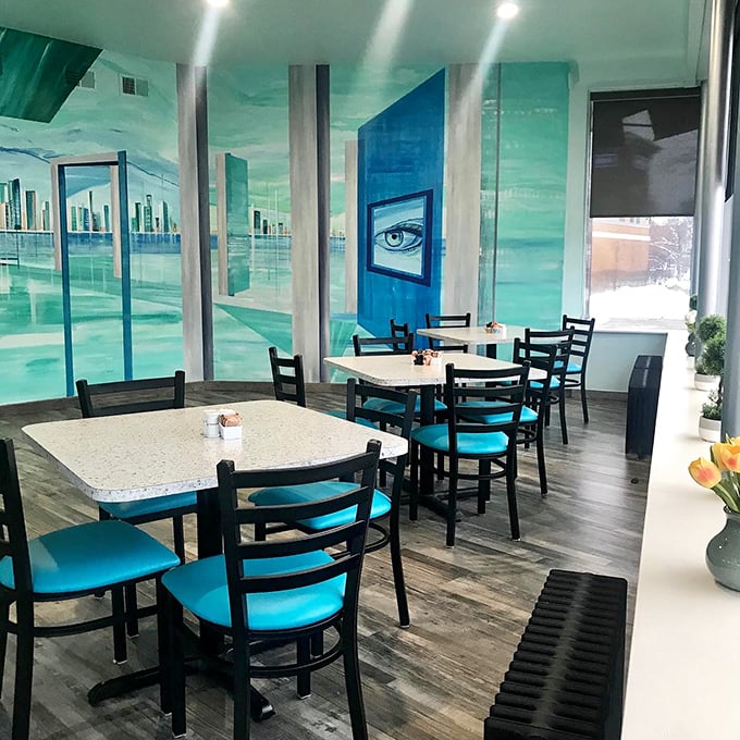 The dining room's dreamy aqua murals transport you oceanside, proving breakfast with a view doesn't require an actual waterfront.