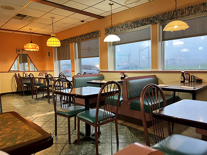 Stained glass pendant lights cast a warm glow over teal booths&mdash;the classic diner setting where memories are made between coffee refills.