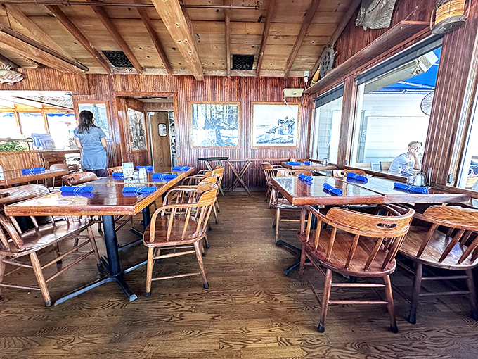 Wooden tables bathed in natural light create a dining room where the ocean is always the guest of honor.