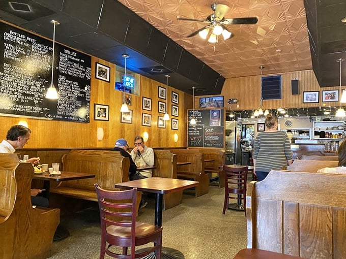 The dining room hums with conversation while wooden booths cradle generations of Richmond diners beneath the glow of unpretentious lighting.
