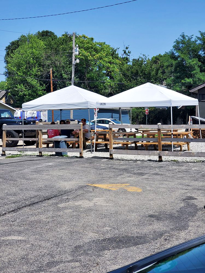 Al fresco dining, BBQ-style. These white tents and wooden benches create the perfect setting for serious meat appreciation.