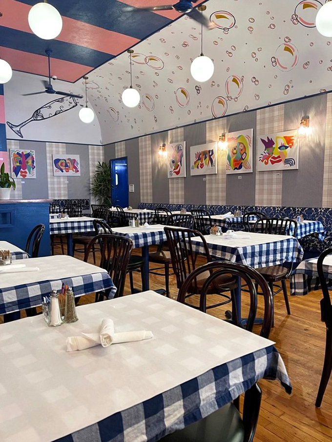 Blue and white checkered tablecloths add a touch of nostalgic charm to a dining room that feels both trendy and timeless.