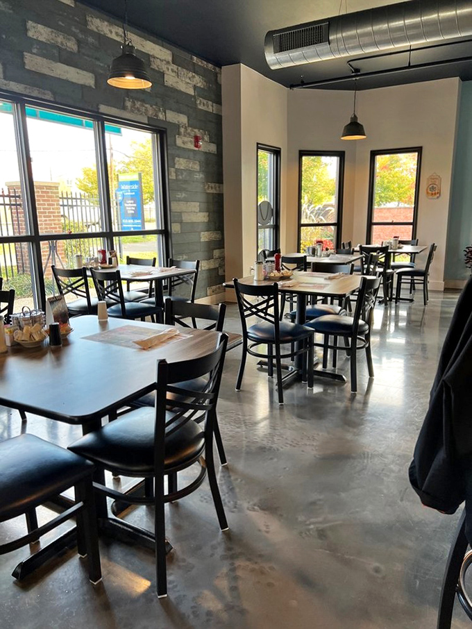 The dining area whispers "stay awhile" with its stone accent wall, polished concrete floors, and windows that invite the outside world in.