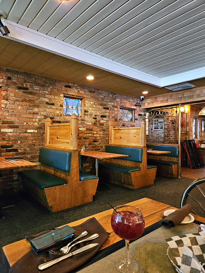 Cozy booths against exposed brick walls create that perfect "I've discovered something special" feeling. The kind of corner where food memories are made.