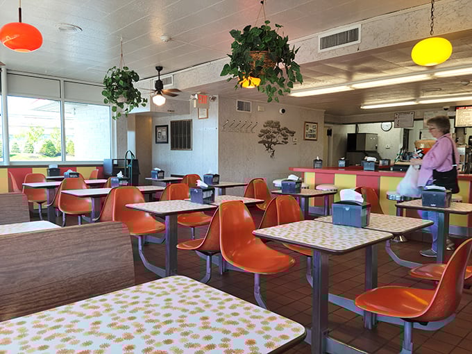 The dining room at Speck's feels like a community living room, where hanging plants and orange chairs have witnessed countless family celebrations.