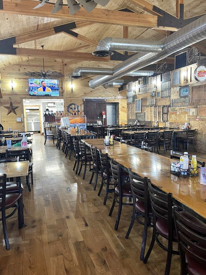 Long tables that tell stories of countless barbecue pilgrimages. The exposed ductwork and wooden beams create a cathedral-like space dedicated to smoked meat worship.