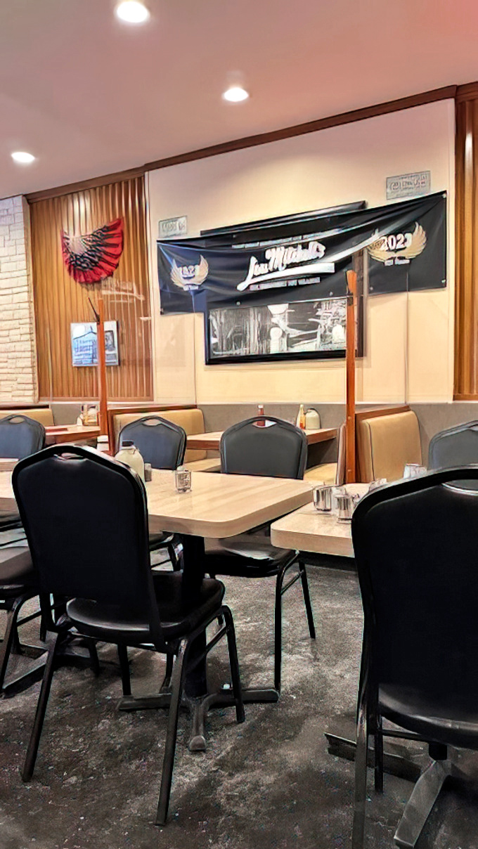 Tables waiting for the next round of breakfast enthusiasts. That Lou Mitchell's banner isn't just decoration&mdash;it's a promise of consistency in a changing world.