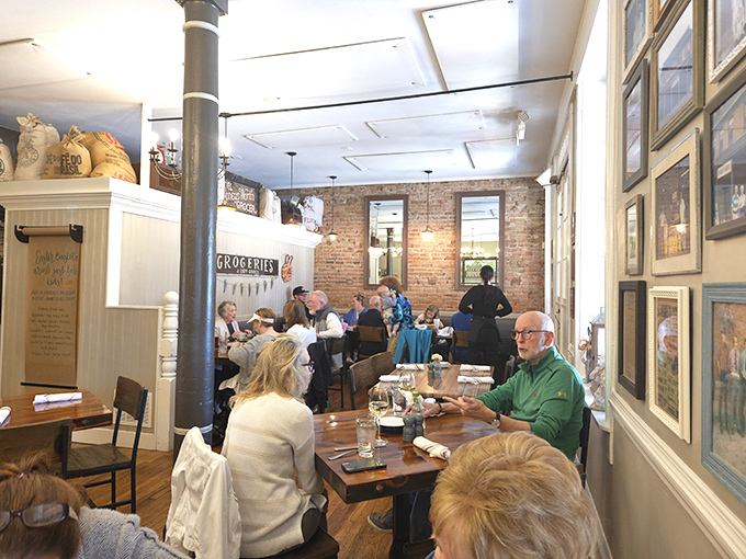 The "Groceries" sign nods to Hendel's market origins, while exposed brick and wooden tables create a dining room where history and hospitality share equal billing.