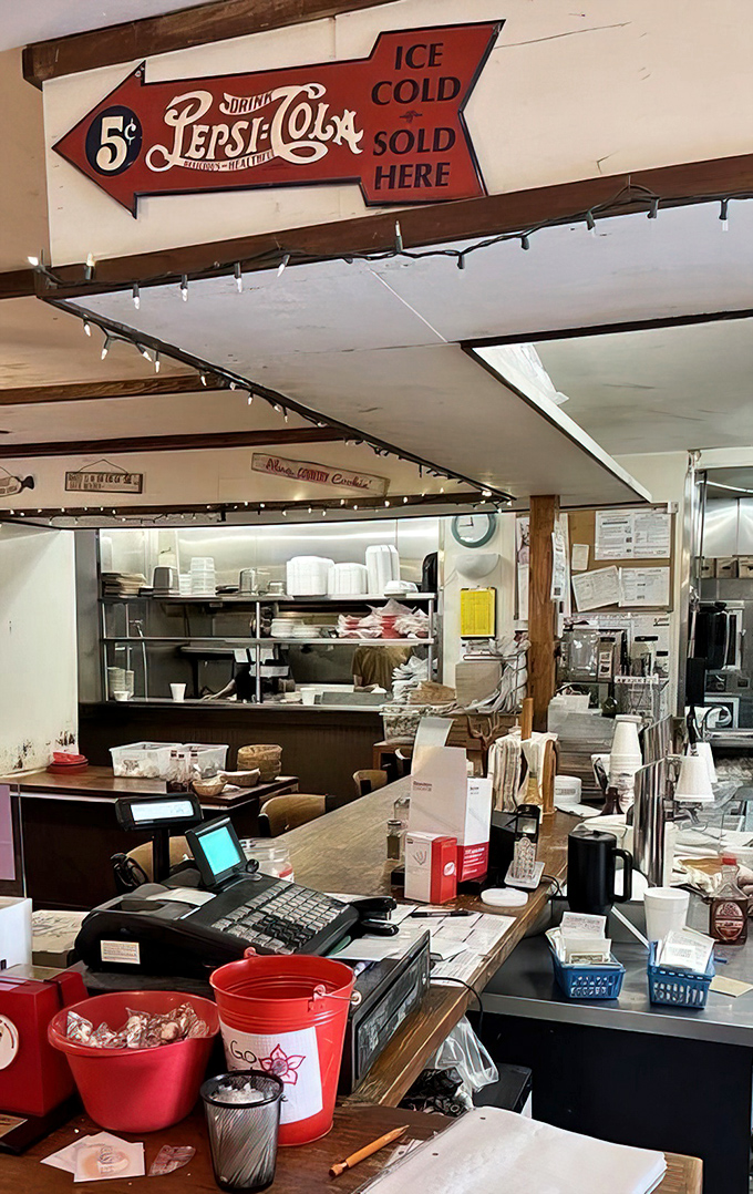 Vintage signs and twinkling lights create the backdrop for a counter where coffee flows and stories grow taller with each refill.