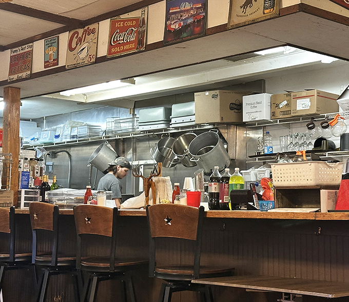 The open kitchen &ndash; culinary theater where spatulas fly and orders materialize into plates of happiness under vintage Coca-Cola signs.