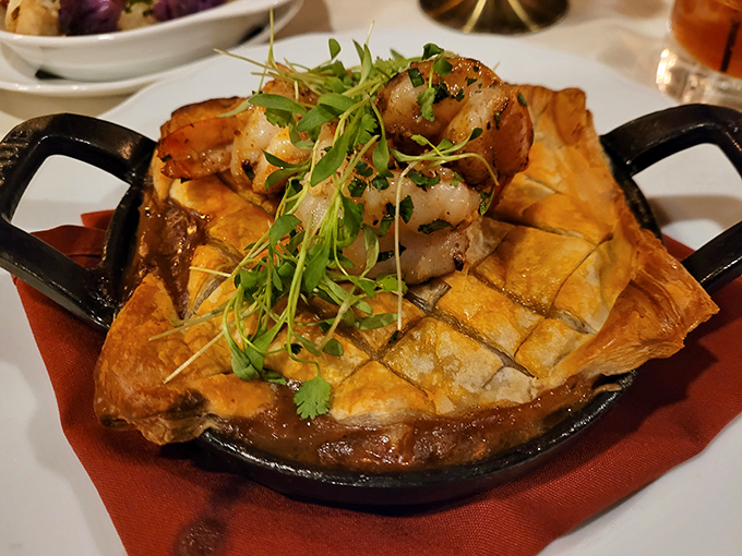 This isn't just pot pie—it's a puff pastry cathedral housing tender shrimp in a savory sea, topped with microgreens like a tiny edible garden.