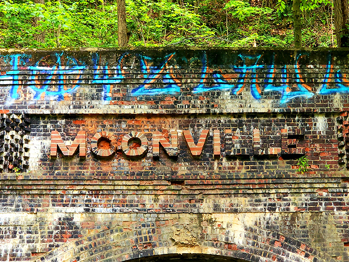 The name "MOONVILLE" stands defiant against the weathered brick, a bold reminder of what was once a thriving railroad community.