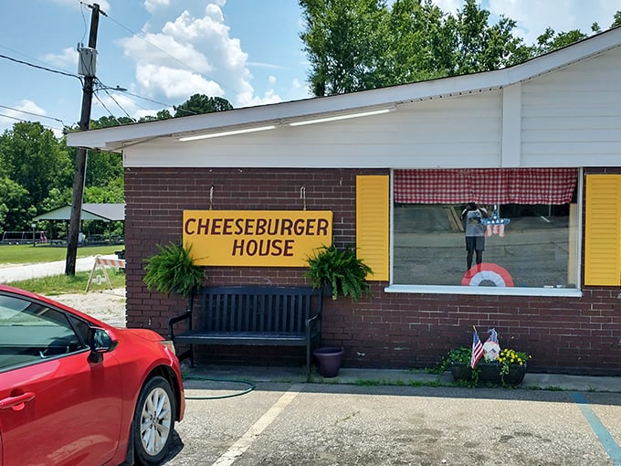 The cheerful yellow sign and welcoming bench say "come on in" &ndash; while the potted plants add a touch of homey charm.