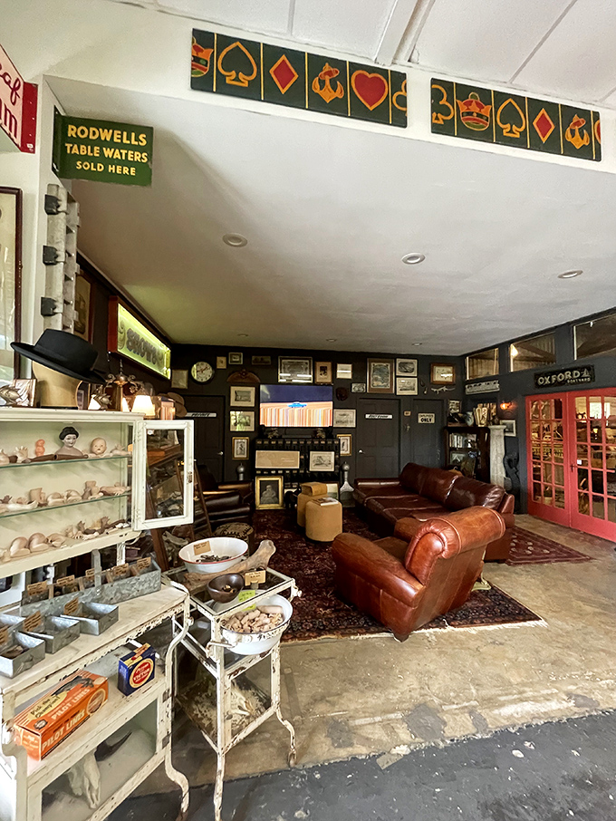 The leather sofa corner looks like it belongs in a private club where important decisions are made over very good whiskey.