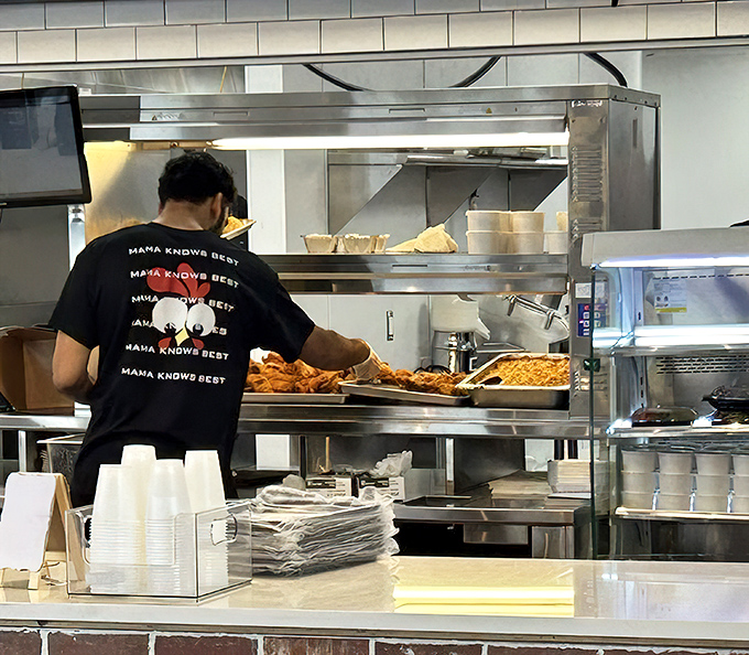 The keepers of the secret recipes, working their magic while you wait. Their t-shirts say it all: when it comes to fried chicken, Mama absolutely knows best.