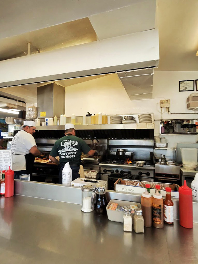 The wizards behind the curtain, wearing their "Don't Worry Be Happy" philosophy on their backs. Breakfast alchemy in progress.