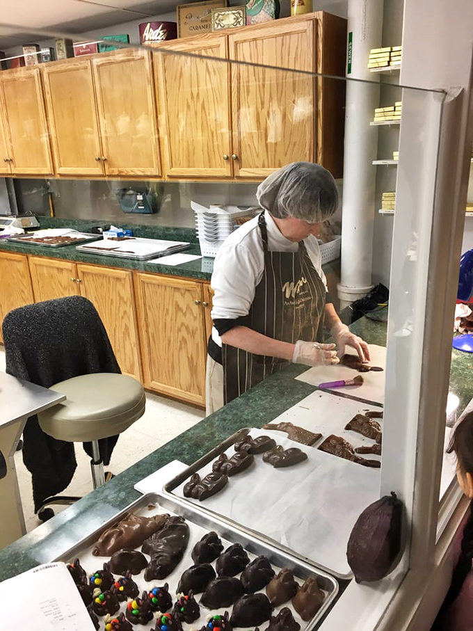 Artisans at work, crafting chocolate delights with the focus of a surgeon and the soul of a poet. This is where magic happens, one truffle at a time.
