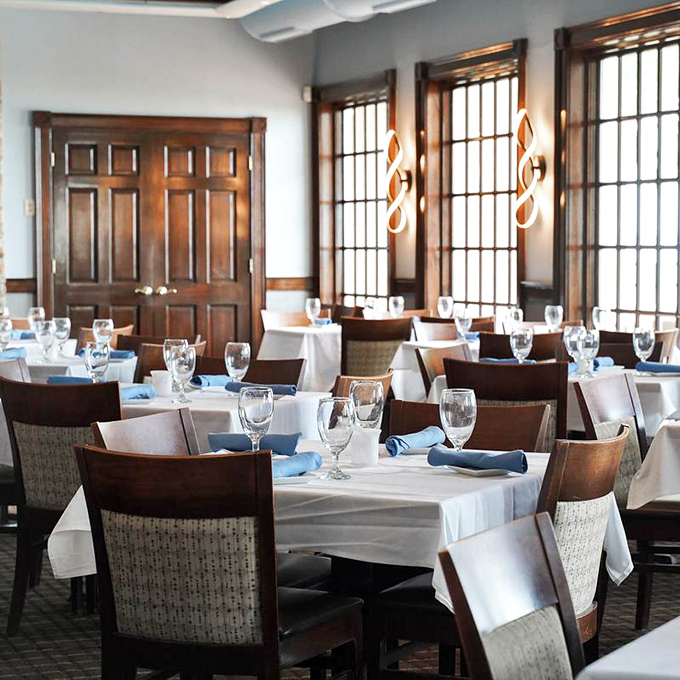 White tablecloths and blue napkins—the dining room dressed in coastal colors that whisper "the seafood here means business."