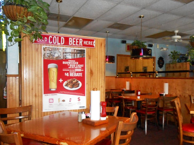 Red cushions pop against natural wood in a dining room that says, "Stay awhile, order another round, there's no rush here."