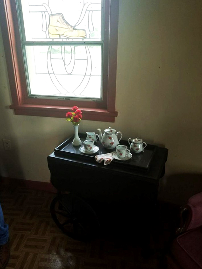 Teatime takes on storybook charm beneath stained glass boot windows. The perfect setting for a "sole-ful" conversation.