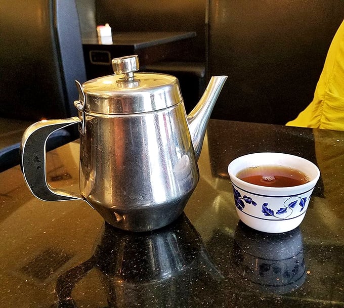 The humble teapot ritual &ndash; where every great Chinese feast begins and ends. This stainless steel pot delivers liquid comfort alongside a delicate blue and white cup of fragrant tea.