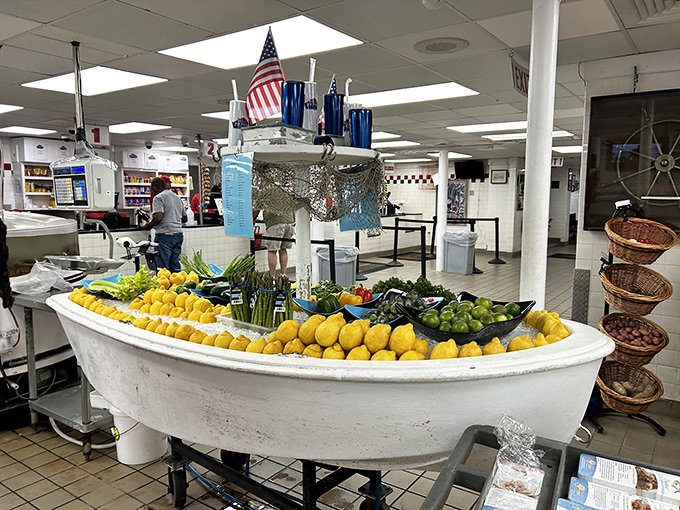 A boat brimming with lemons and produce sits like a colorful centerpiece in the market. Nautical d&eacute;cor that's actually functional!