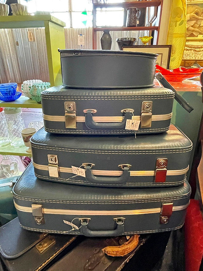 A tower of vintage suitcases stands ready for imaginary journeys, each scratch and travel sticker hinting at adventures from a time before rolling luggage.