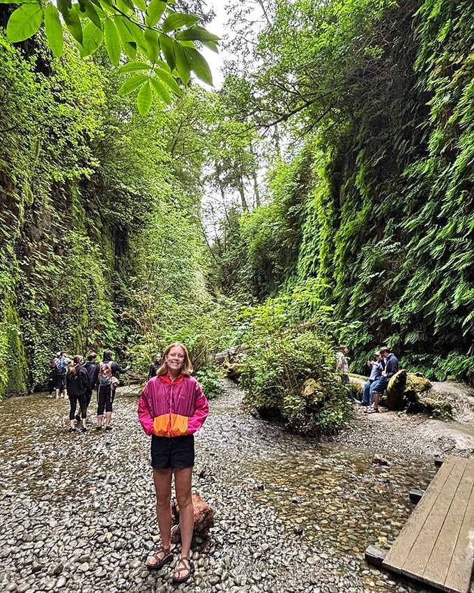 Fellow explorers pause to soak in the majesty. That colorful jacket is the only non-green item that doesn't seem out of place.