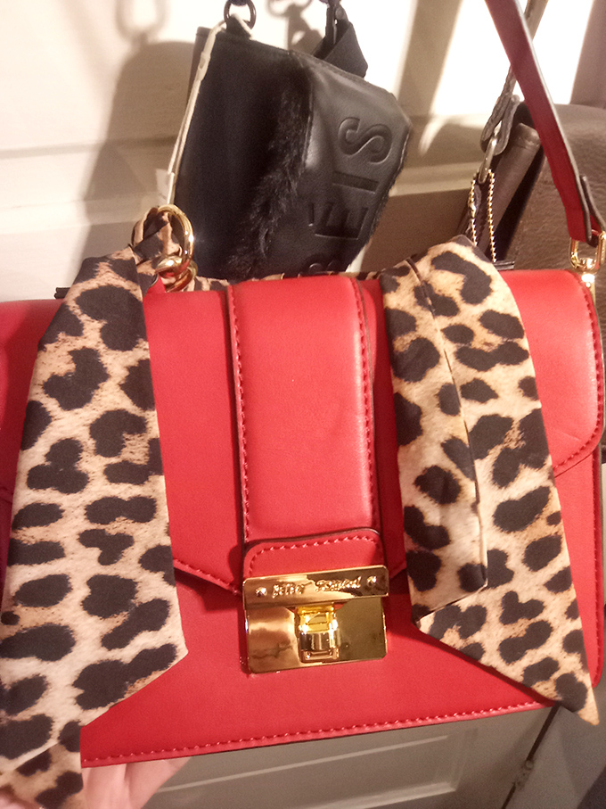 This bold red handbag with leopard accents isn't just an accessory&mdash;it's waiting to become the conversation piece in someone's collection.