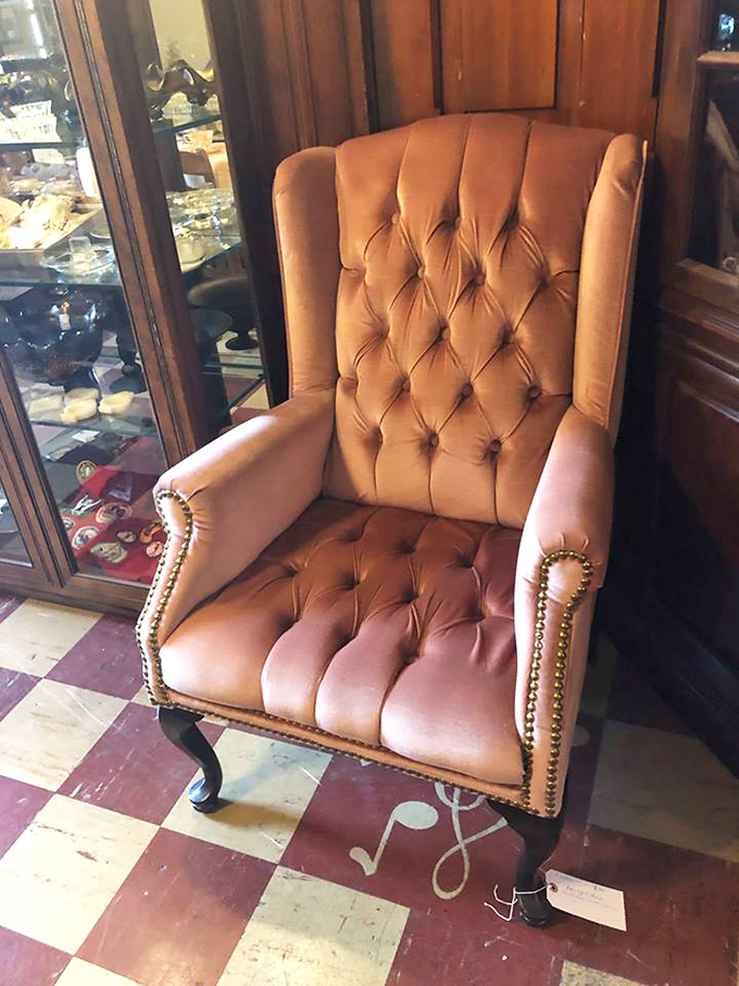 That tufted leather chair isn't just seating&mdash;it's a throne waiting for someone who appreciates the dignified comfort of another era.