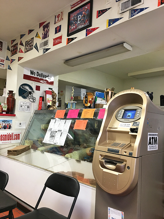 The intersection of commerce and cuisine, where an ATM stands ready for those who underestimated their sandwich needs. Always bring backup funds.