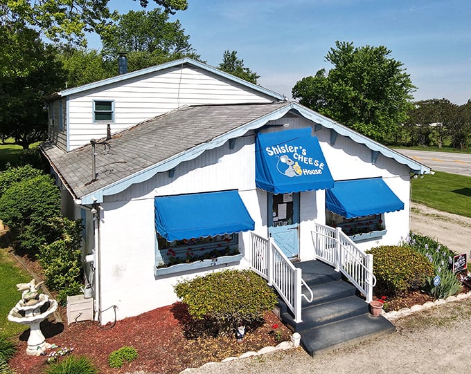 From above, it looks unassuming. Inside, it's a cheese lover's cathedral. The blue awnings beckon road-weary travelers to dairy salvation.