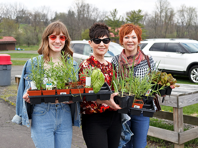 Plant ladies with their treasures! The happiness on their faces says, "Yes, I absolutely needed more herbs, and no, I don't care what my spouse thinks."