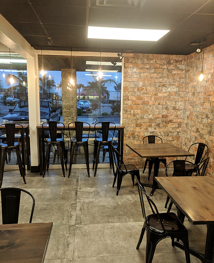 The dining area's exposed brick and wooden tables create the perfect stage for the main event: your imminent donut feast.