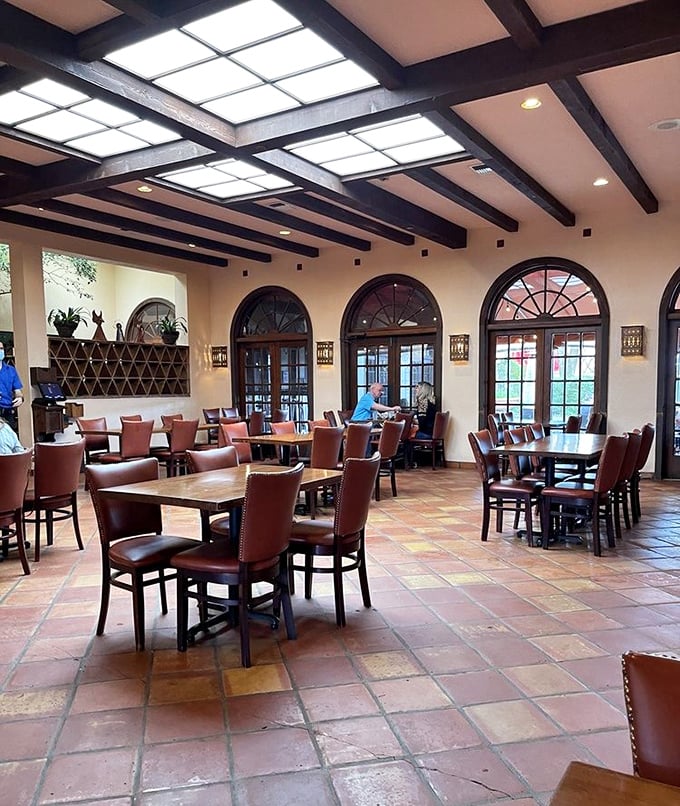 Arched windows flood the dining room with natural light, highlighting the restaurant's warm, inviting atmosphere and thoughtful design.