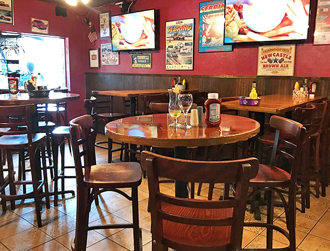 The warm wood tones and burgundy walls create that "neighborhood joint" atmosphere where everybody might not know your name yet, but they're happy to learn it.